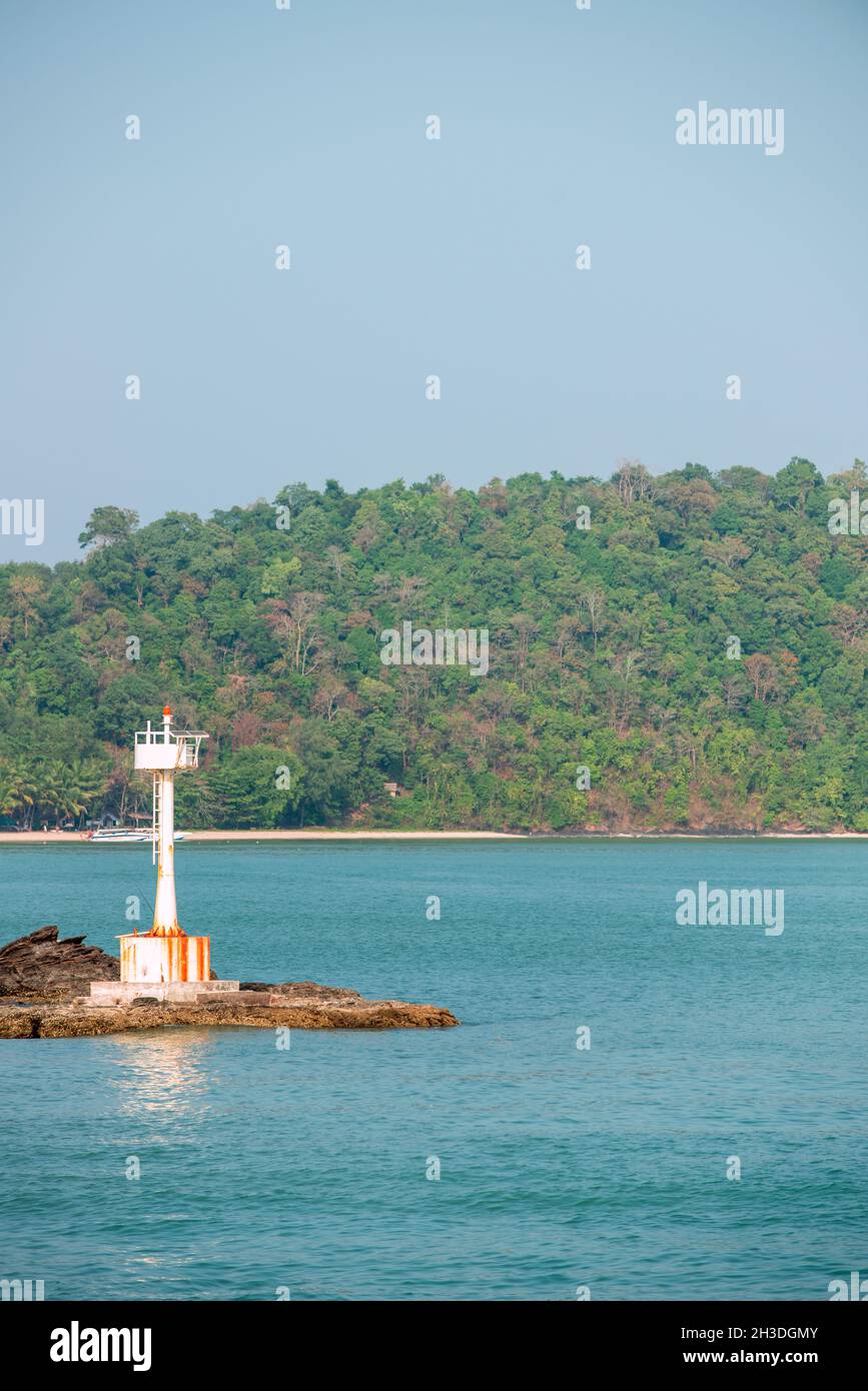Maritime signal lighthouse painted white on some rocks at the exit of ...