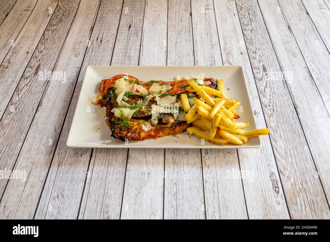 Mediterranean schnitzel with Parmesan cheese slices with pesto sauce ...