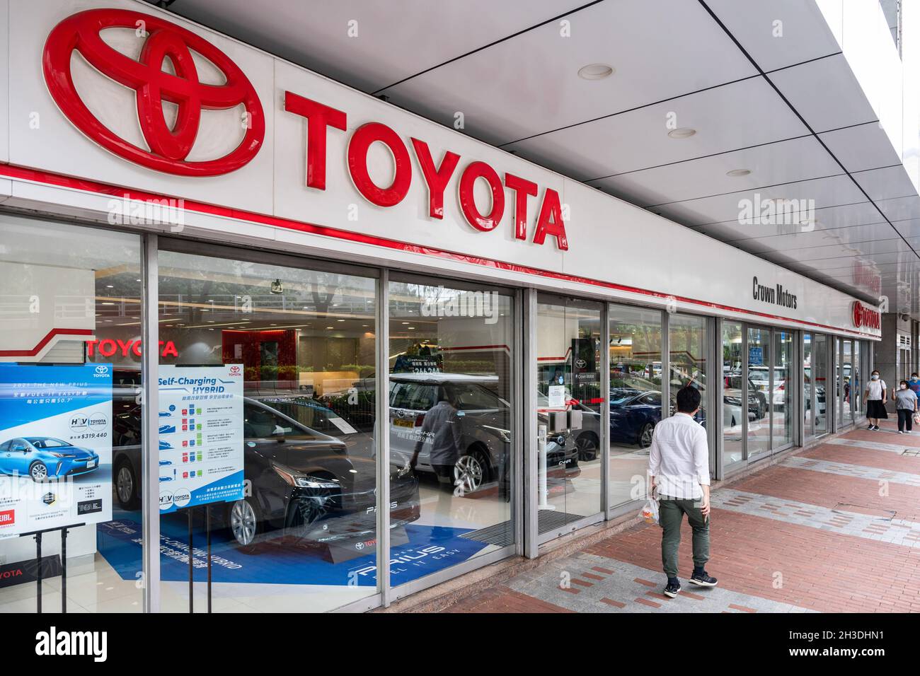 A pedestrian walks past the Japanese multinational automobile ...