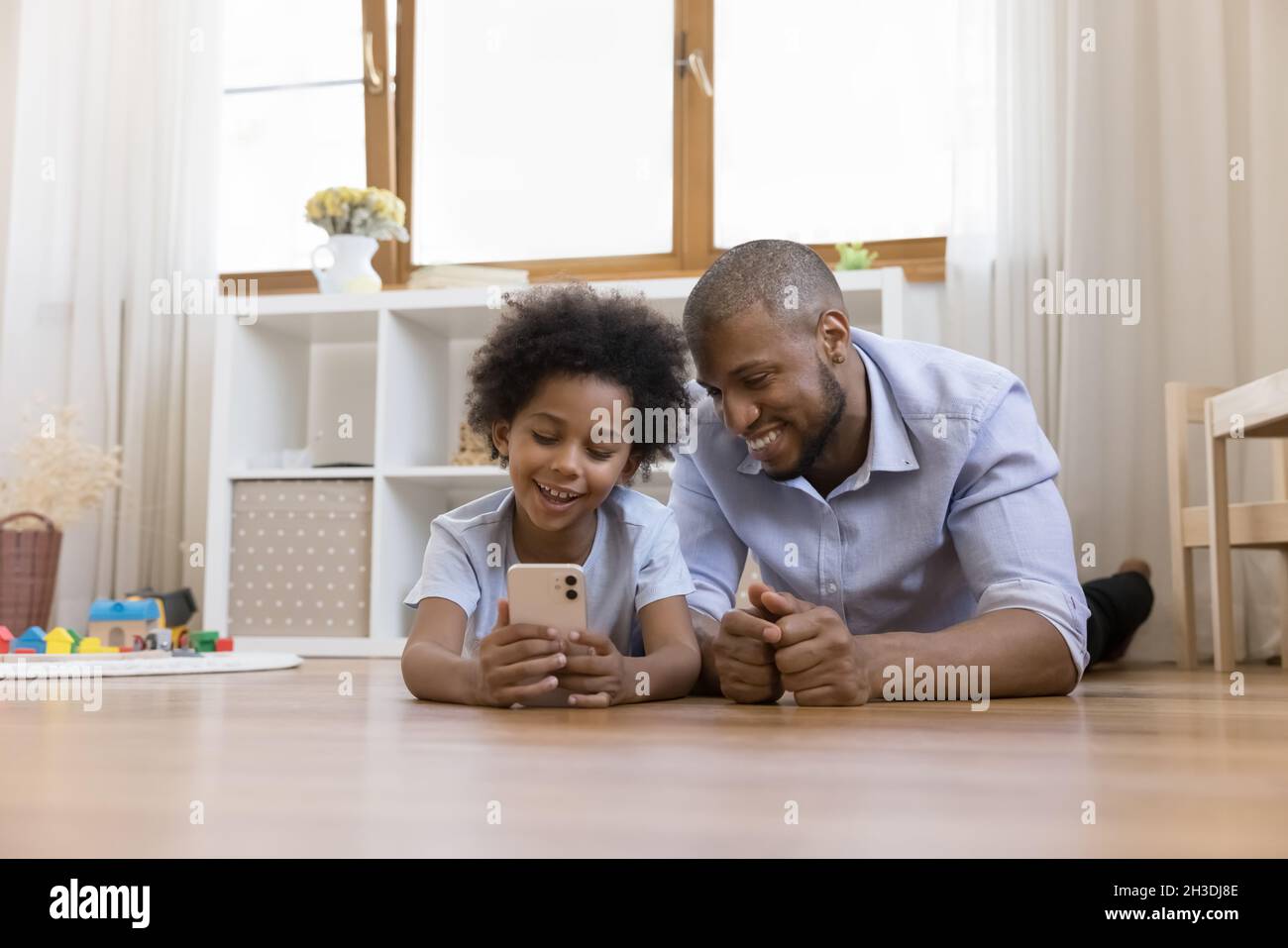 Happy little african american kid boy using cellphone with father Stock ...