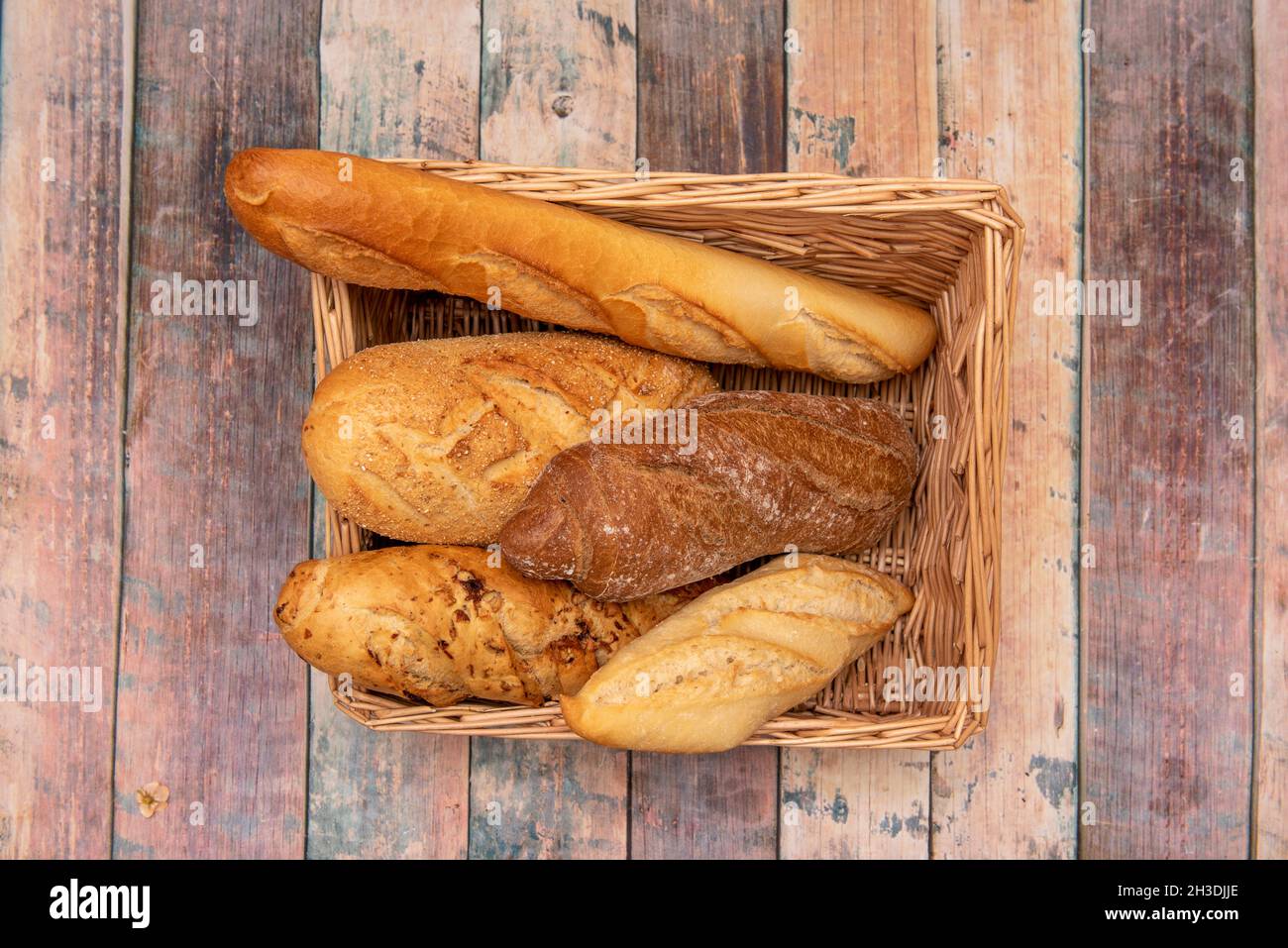 Basket of assorted breads. Village bread, rye bread, onion bread ...
