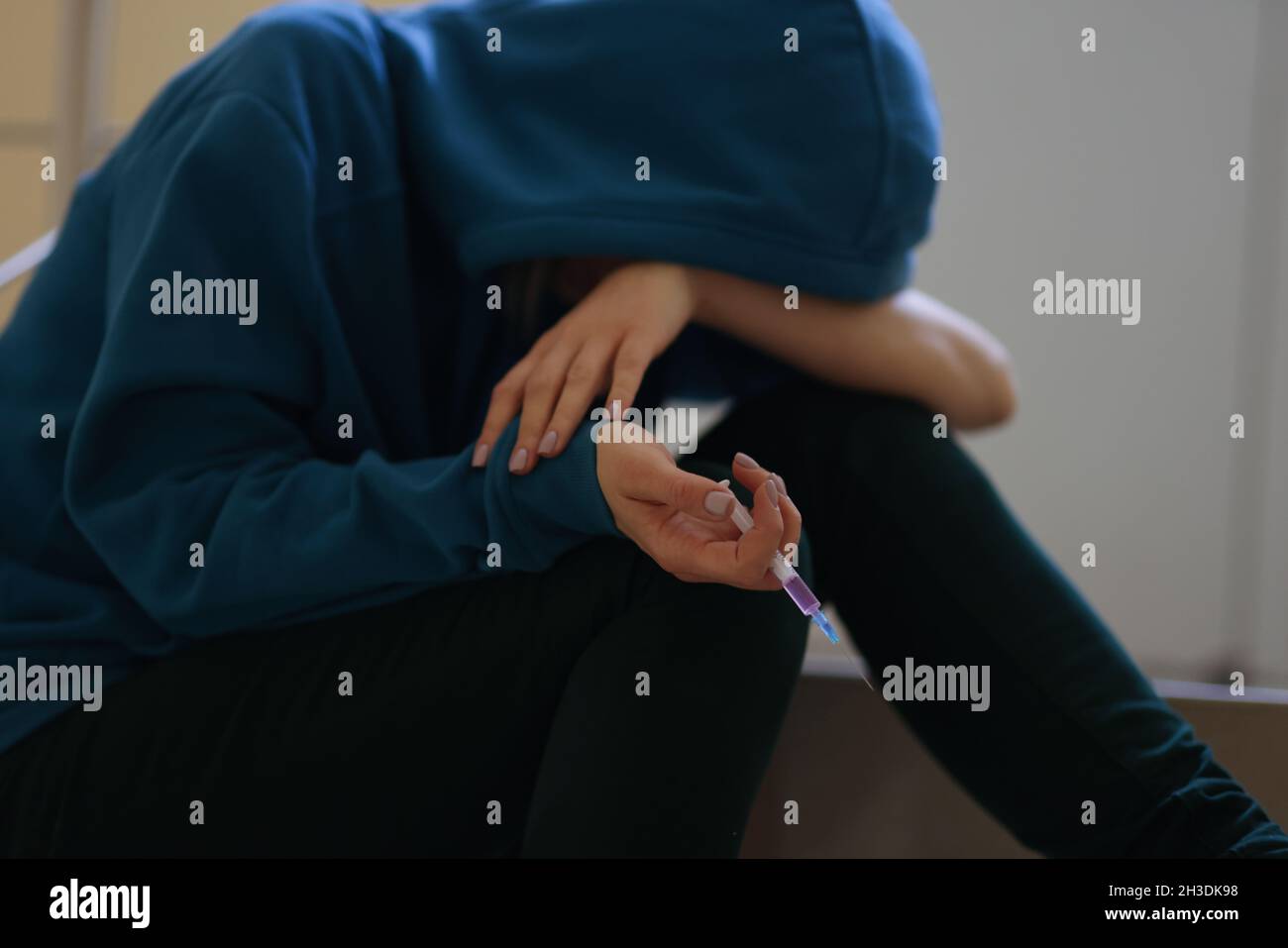 Drug addict person stoned after narcotic injection sitting on floor ...