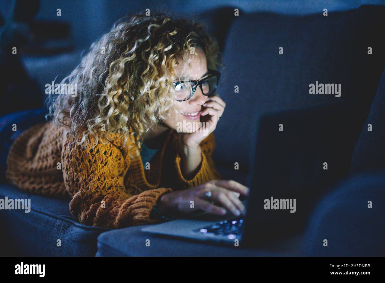 Attractive adult woman smile and use laptop computer and internet ...