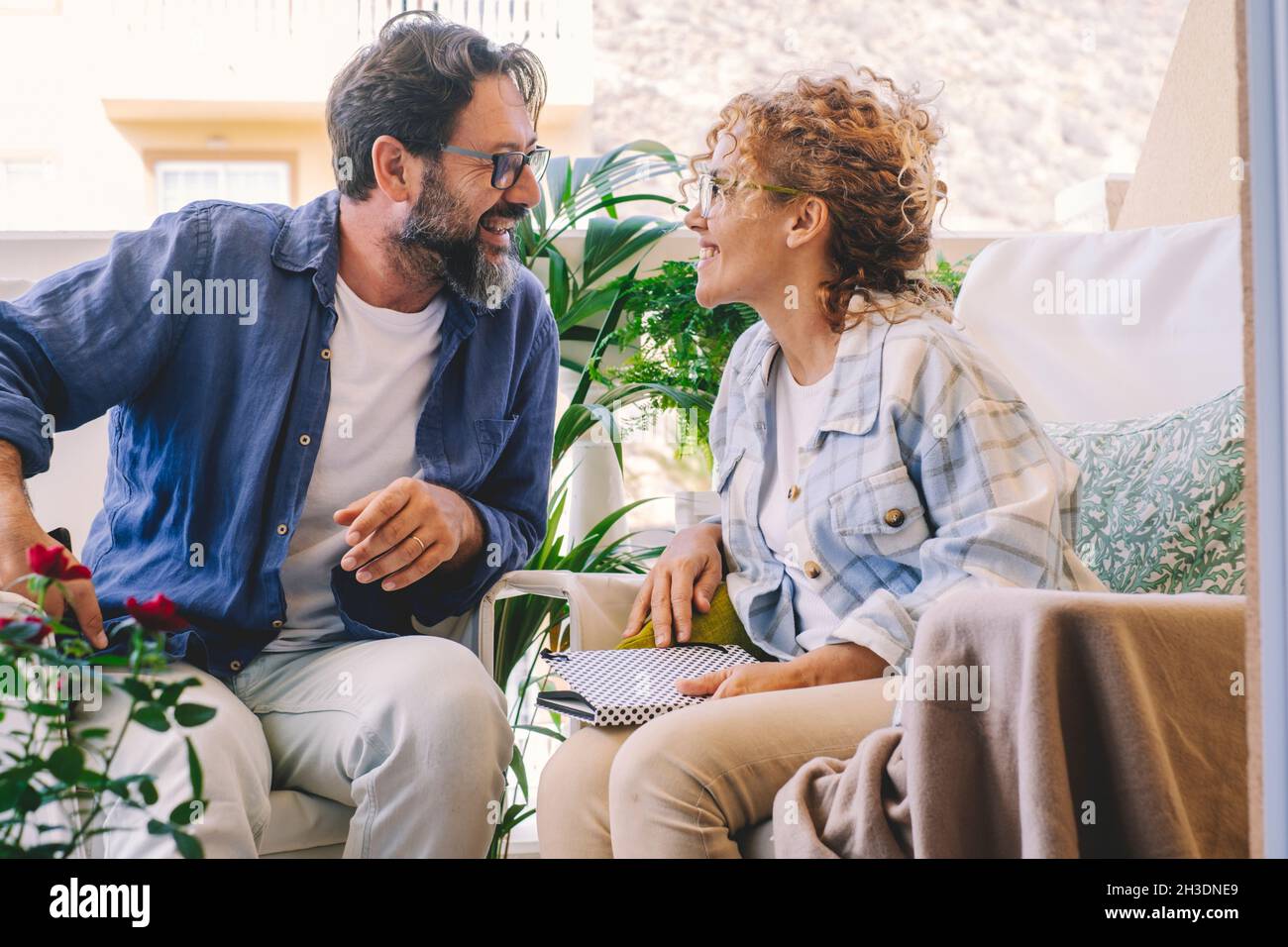 Two caucasian adults sitting on outside chairs hi-res stock photography ...
