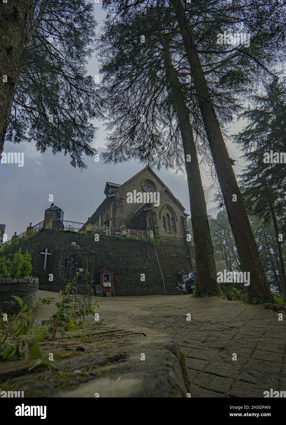 Old catholic church behind the pine trees Stock Photo - Alamy