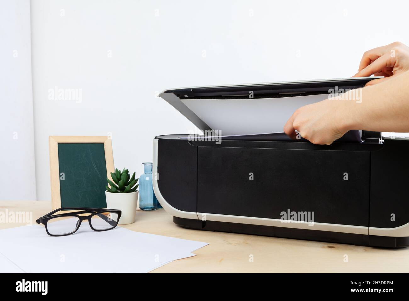 Hands of a woman using a copying machine close up Stock Photo - Alamy