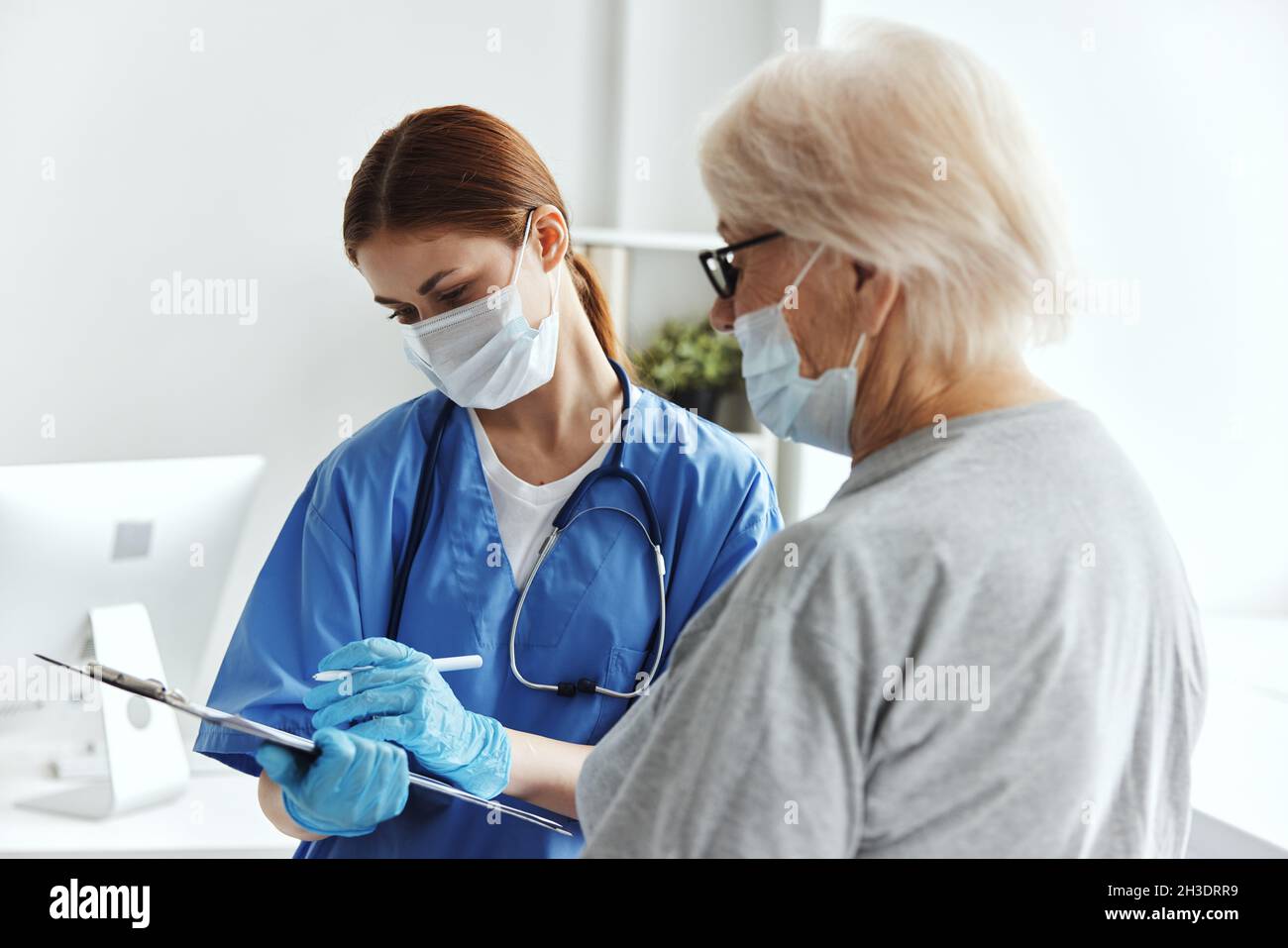 elderly woman and doctor Hospital visit medical office Stock Photo - Alamy