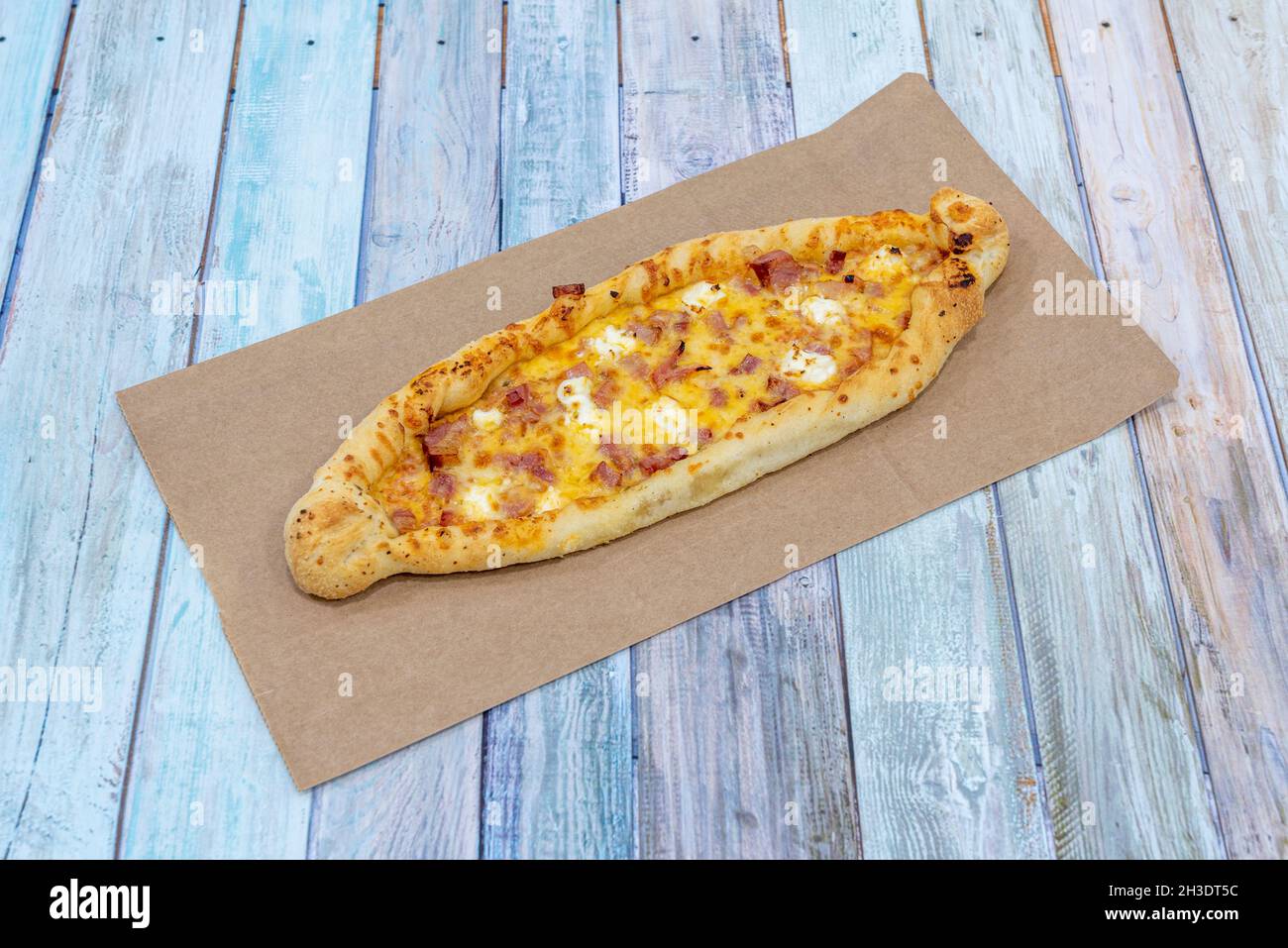 small long pizza with smoked bacon and mozzarella cheese and melted ...