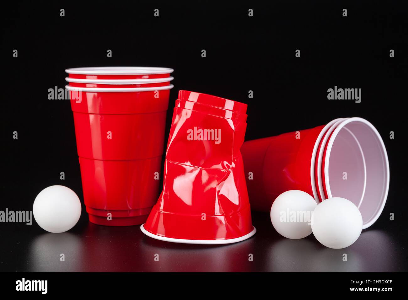 Red plastic cups and ball for game of beer pong Stock Photo - Alamy