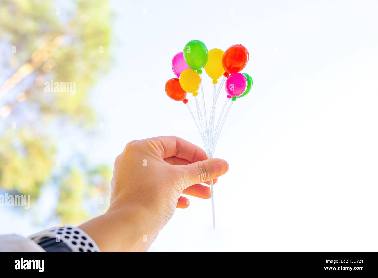 Bunch of colorful tiny plastic balloons in hand Stock Photo - Alamy