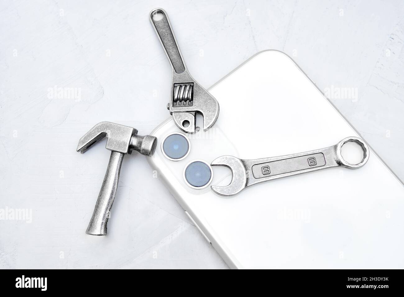 Set of miniature work tools arranged around the smartphone's camera on ...