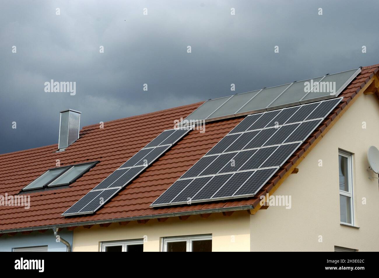 roof with solar installation in bad weather, Germany Stock Photo - Alamy