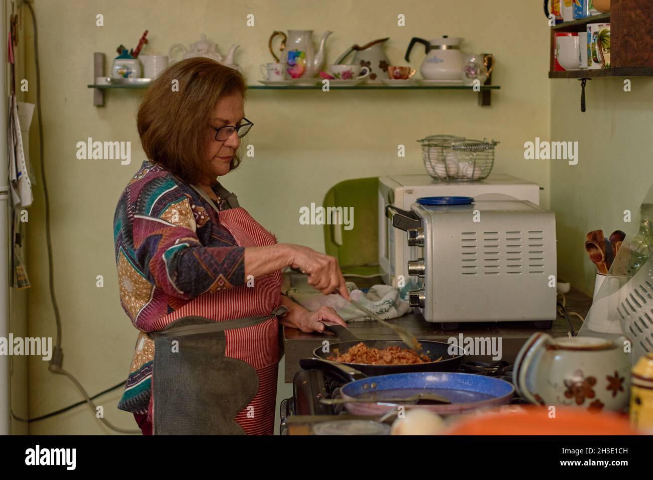 Latin grandmother cooks tacos in traditional Mexican cuisine Stock ...