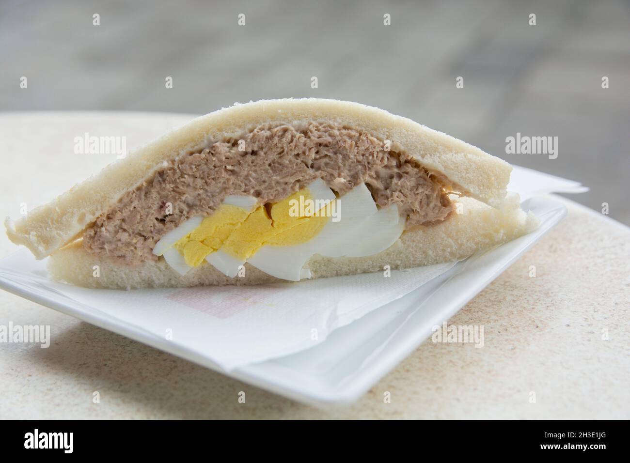 Close up of a Tramezzino, a triangular Italian sandwich constructed ...