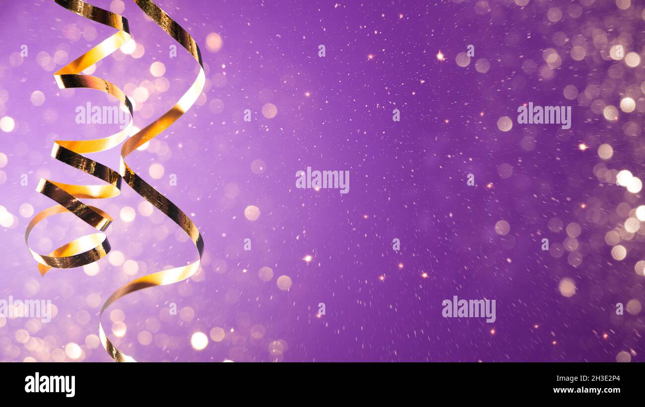 Celebration party background with a golden streamer, glitter, sparks ...