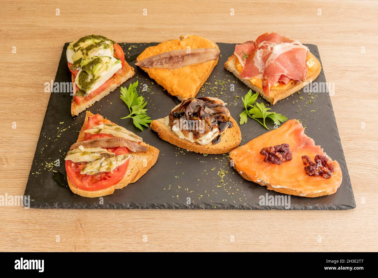 Assorted toast of Norwegian salmon, cheese with ratatouille, cream with ...