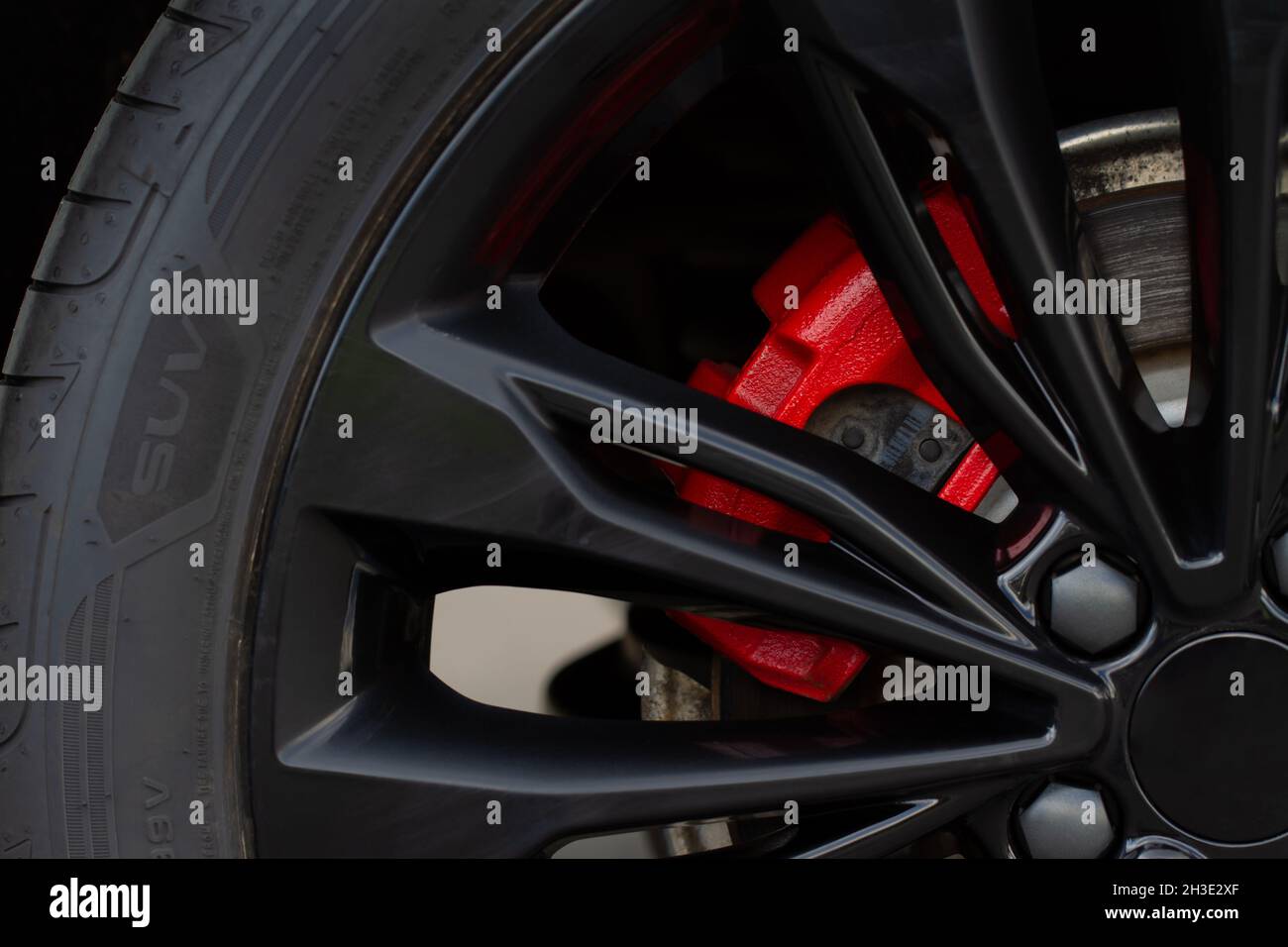 Close up of a modern wheel with red disk brake. Car brakes close up ...