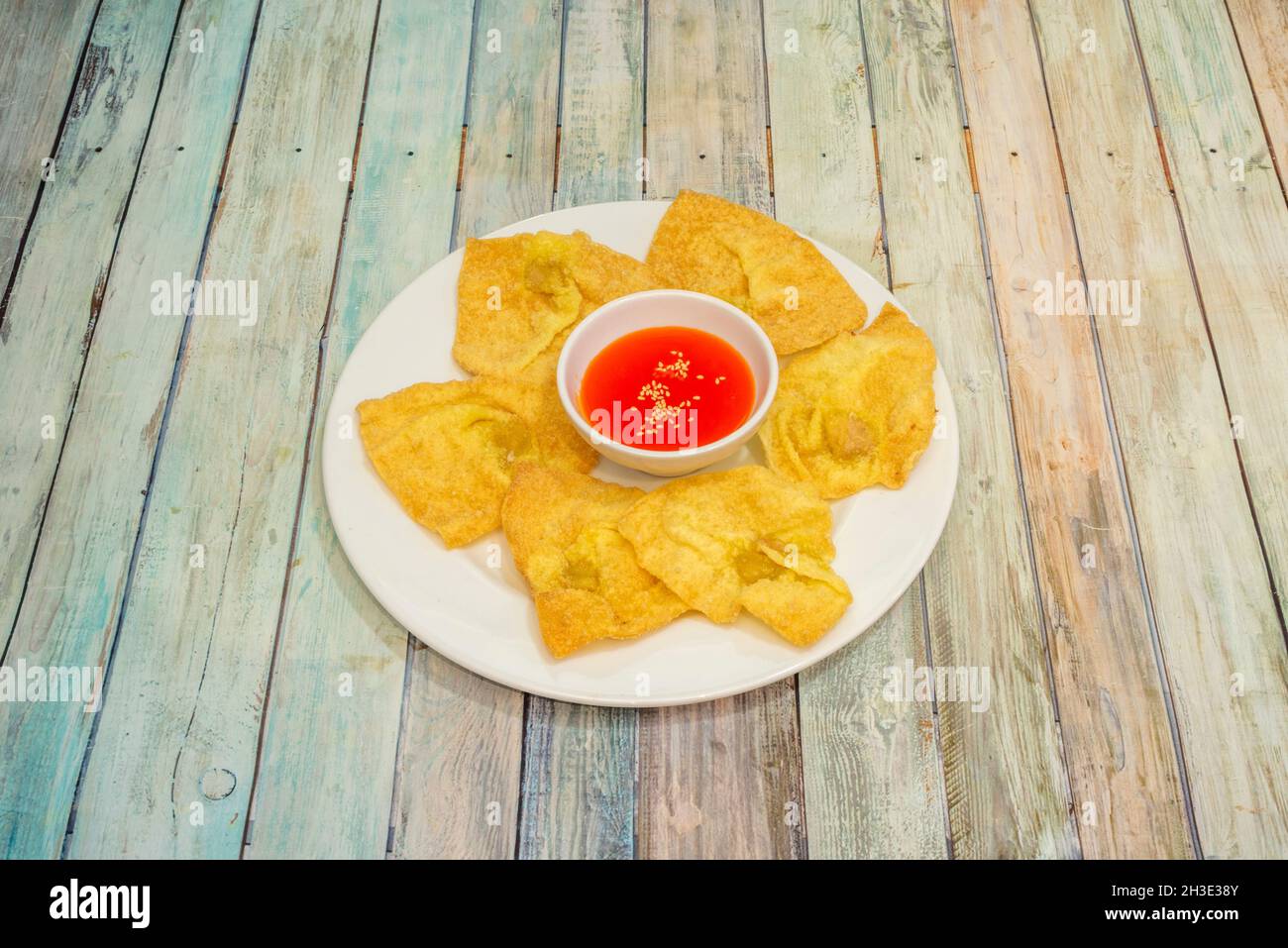 Peruvian-style wantan plate with sweet and sour sauce for dipping in ...