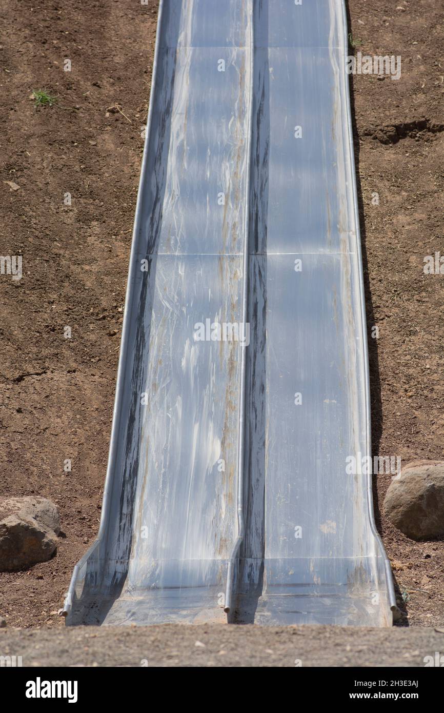 Long and steep metal slide, outdoors Stock Photo - Alamy
