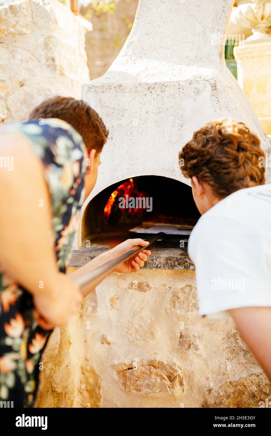Homemade pizza baking with outdoor traditional pizza over Stock Photo ...