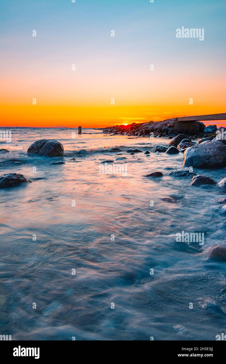 Vertical shot of the ocean on the sunset sky background Stock Photo - Alamy