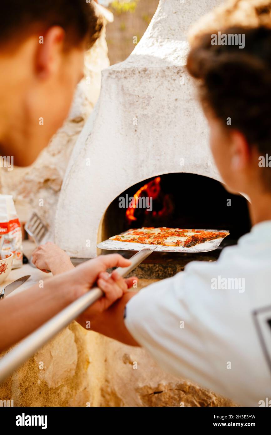 Homemade pizza baking with outdoor traditional pizza over Stock Photo ...