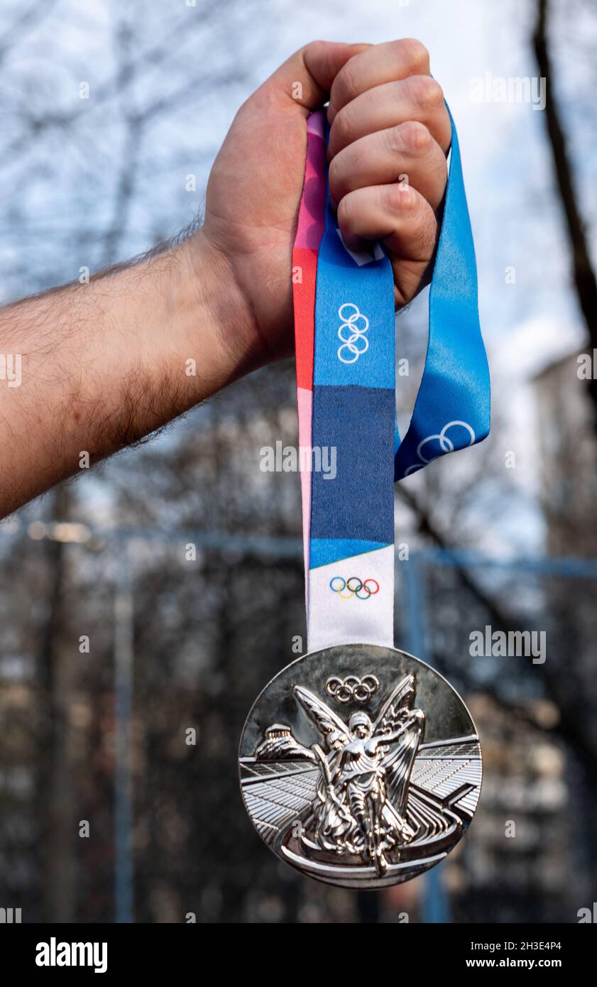 April 17, 2021 Beijing, China. Olympic silver medal in the hand of an ...