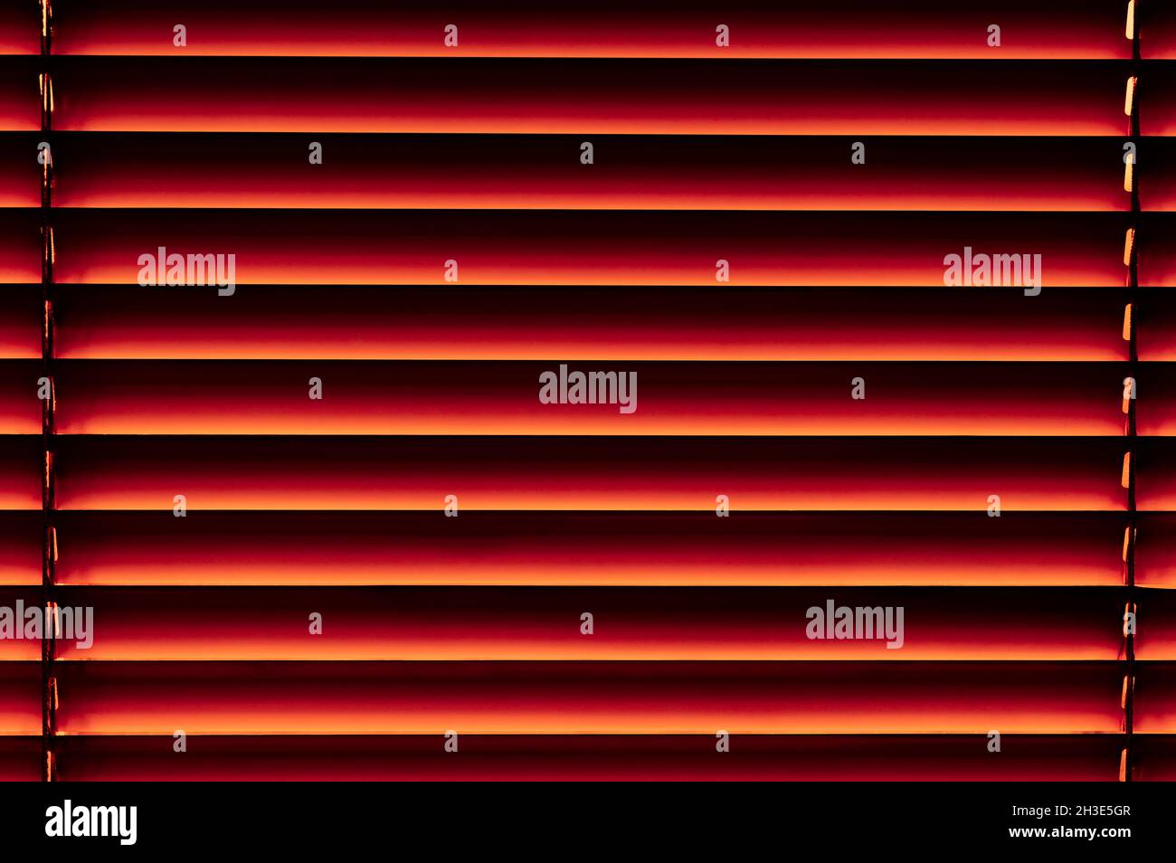 Window blinds are orange with a smooth transition to ruby red and black ...