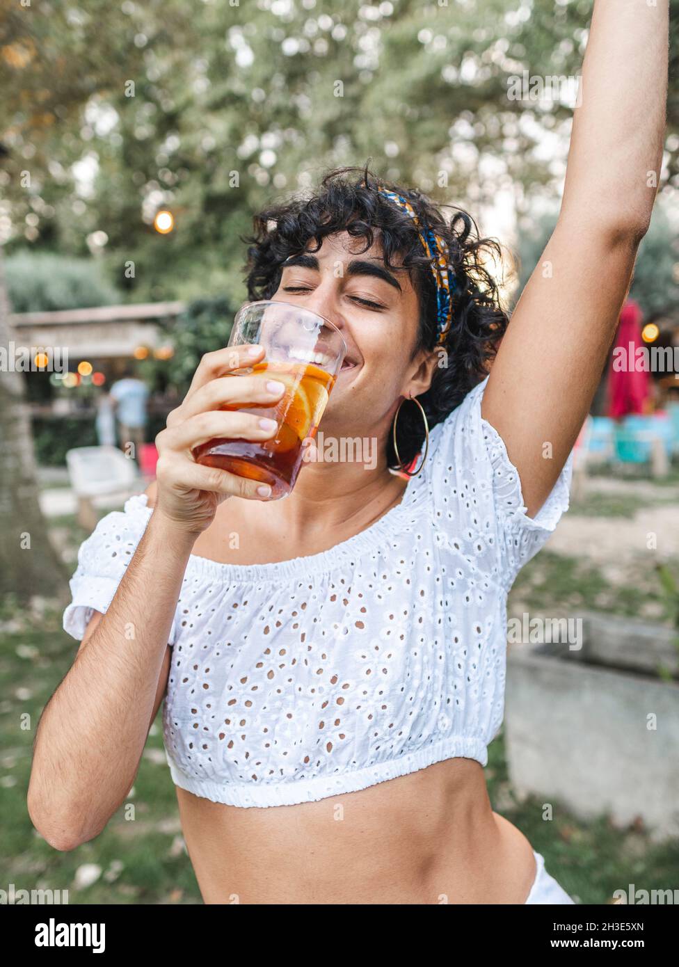 Young woman drinking cocktail dancing hi-res stock photography and ...