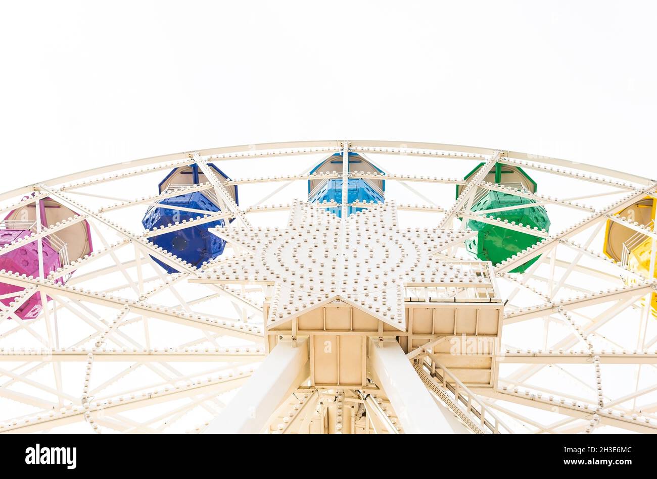 Round public observation wheel with multicolored passenger cabins ...