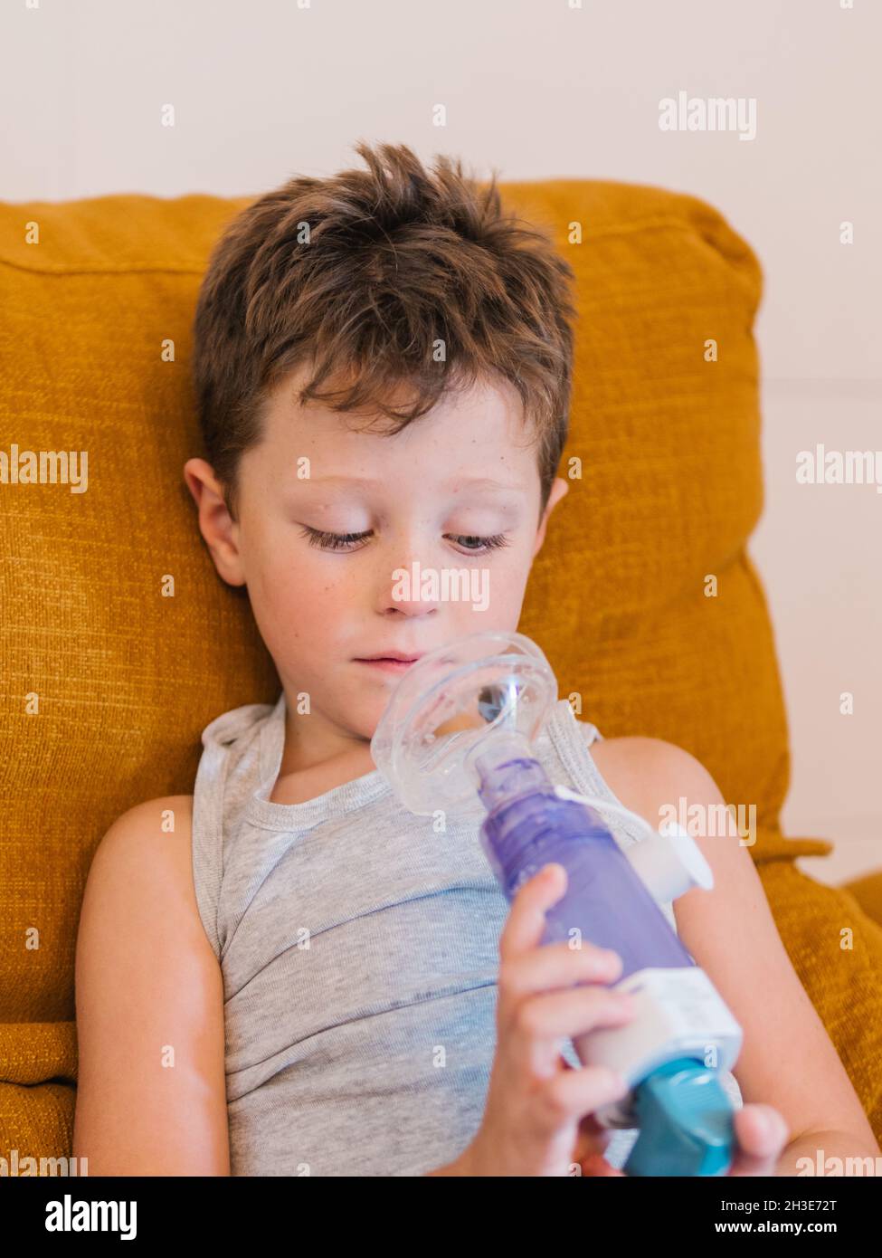 Content sick boy using respirator and breathing oxygen from inhaler ...