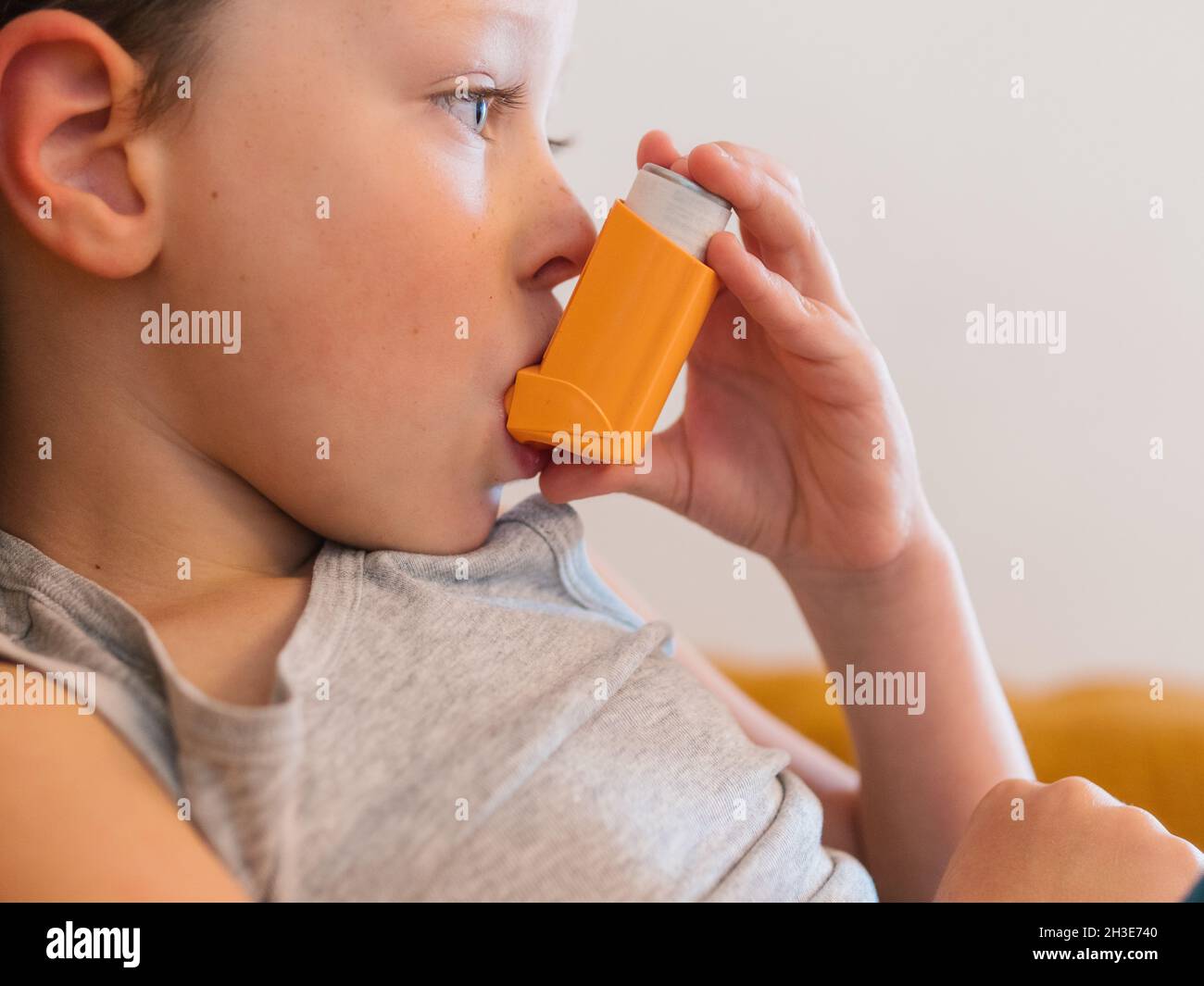 Side view of content sick boy using respirator and breathing oxygen ...