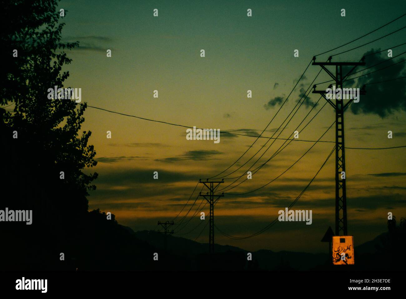 Sunset sky with electric power lines Stock Photo - Alamy