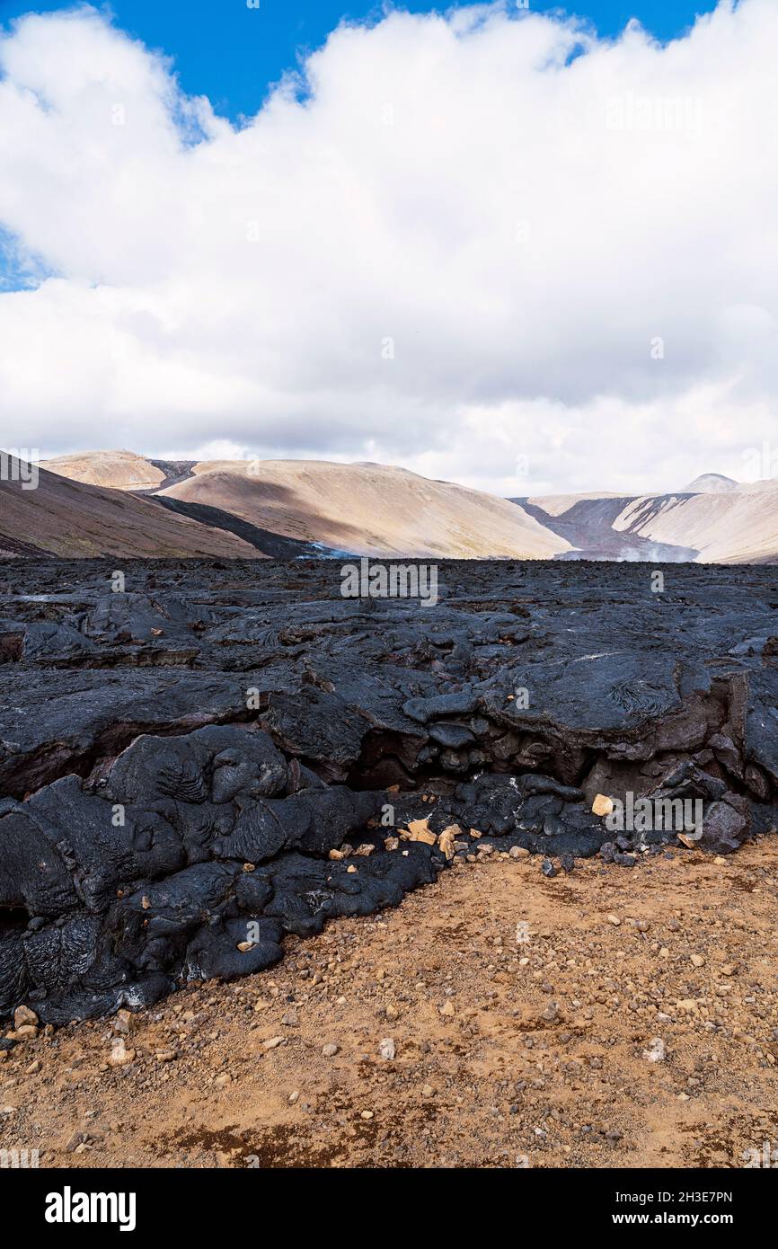 Picturesque scenery of dry black lava on rough terrain of active ...