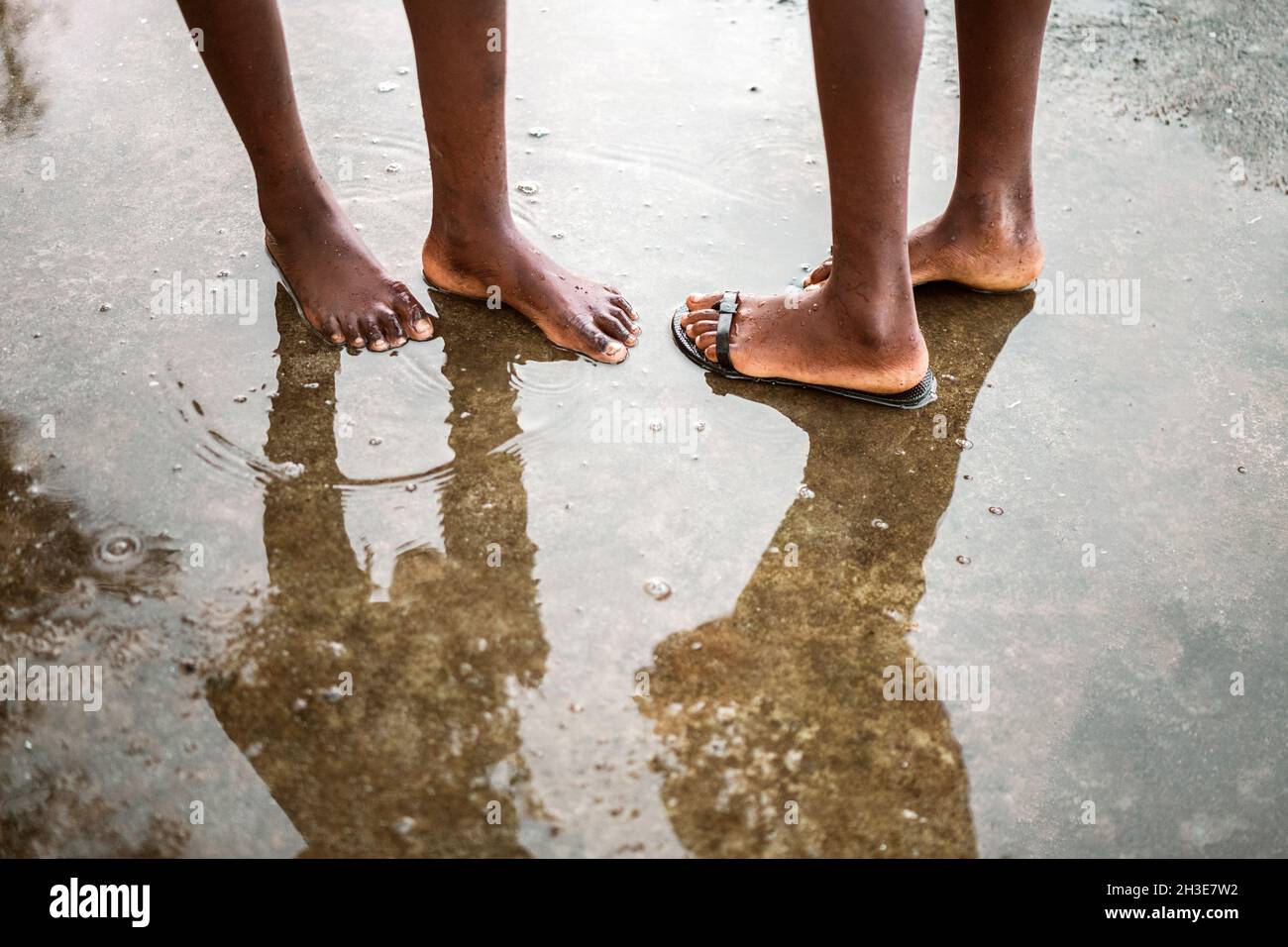 From above of crop unrecognizable black barefoot people standing in ...