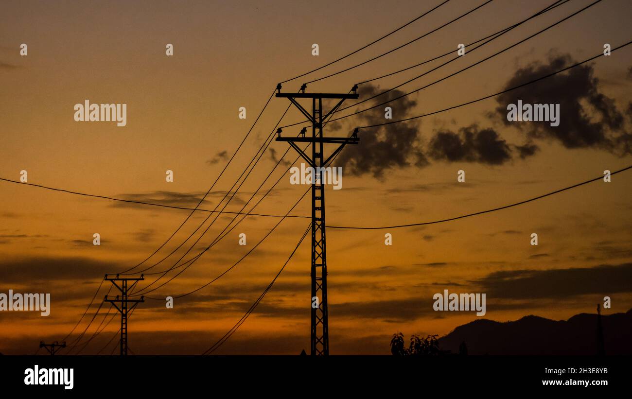 Sunset sky with electric power lines Stock Photo - Alamy