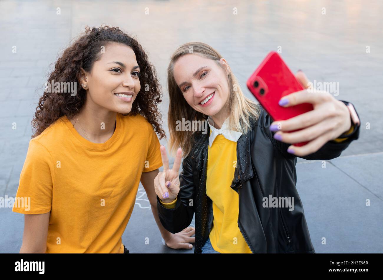 From above of happy young multiethnic female friends smiling and ...