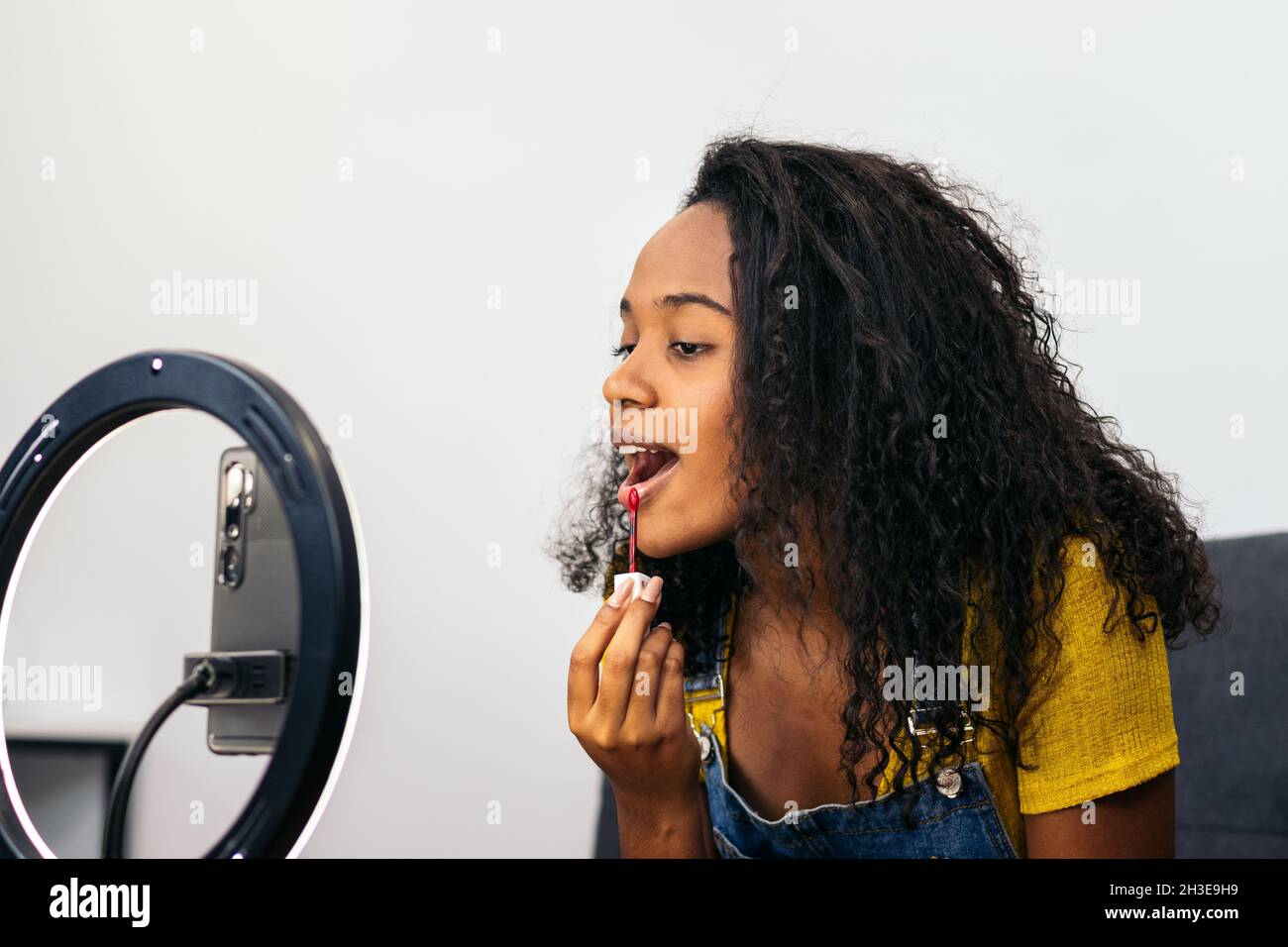 Woman applying lipstick using hi-res stock photography and images - Alamy