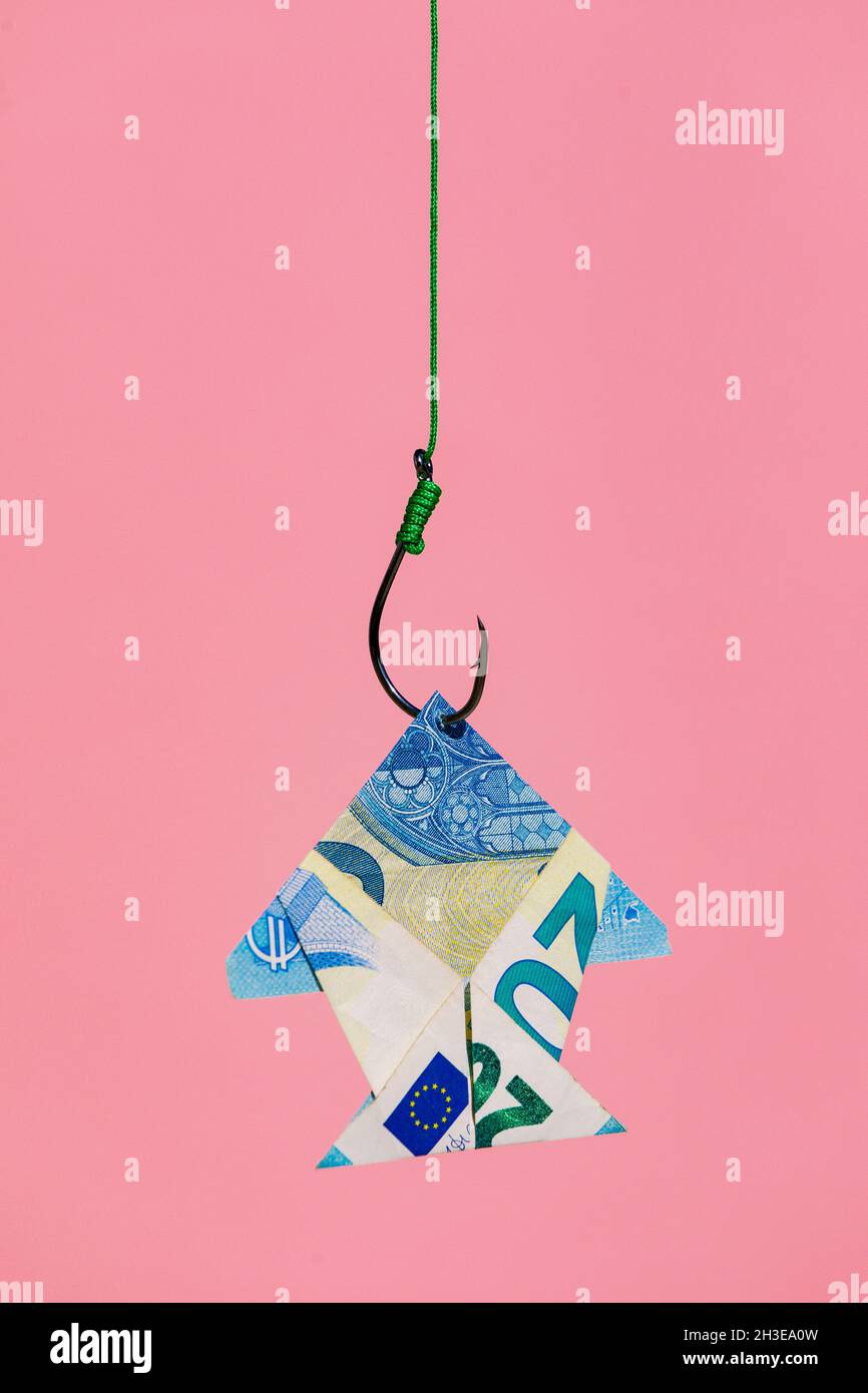 Hook on line pulling origami fish shaped euro banknote as concept of ...