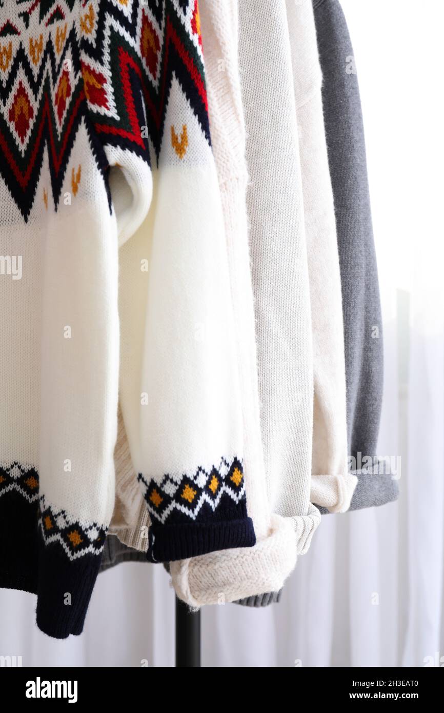 Winter clothes hanging on wardrobe rack indoor Stock Photo - Alamy
