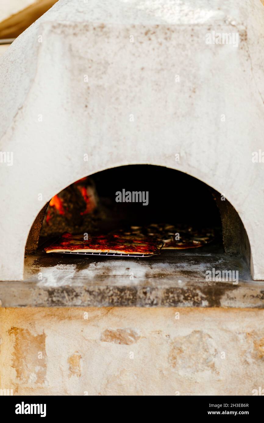 Homemade pizza baking with outdoor traditional pizza over Stock Photo ...