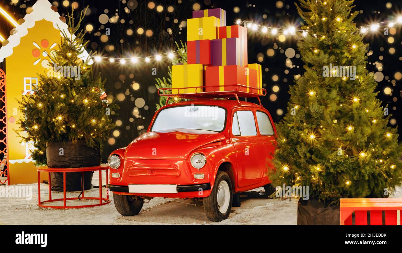 Christmas red car with gifts on the roof. A real vintage red car ...
