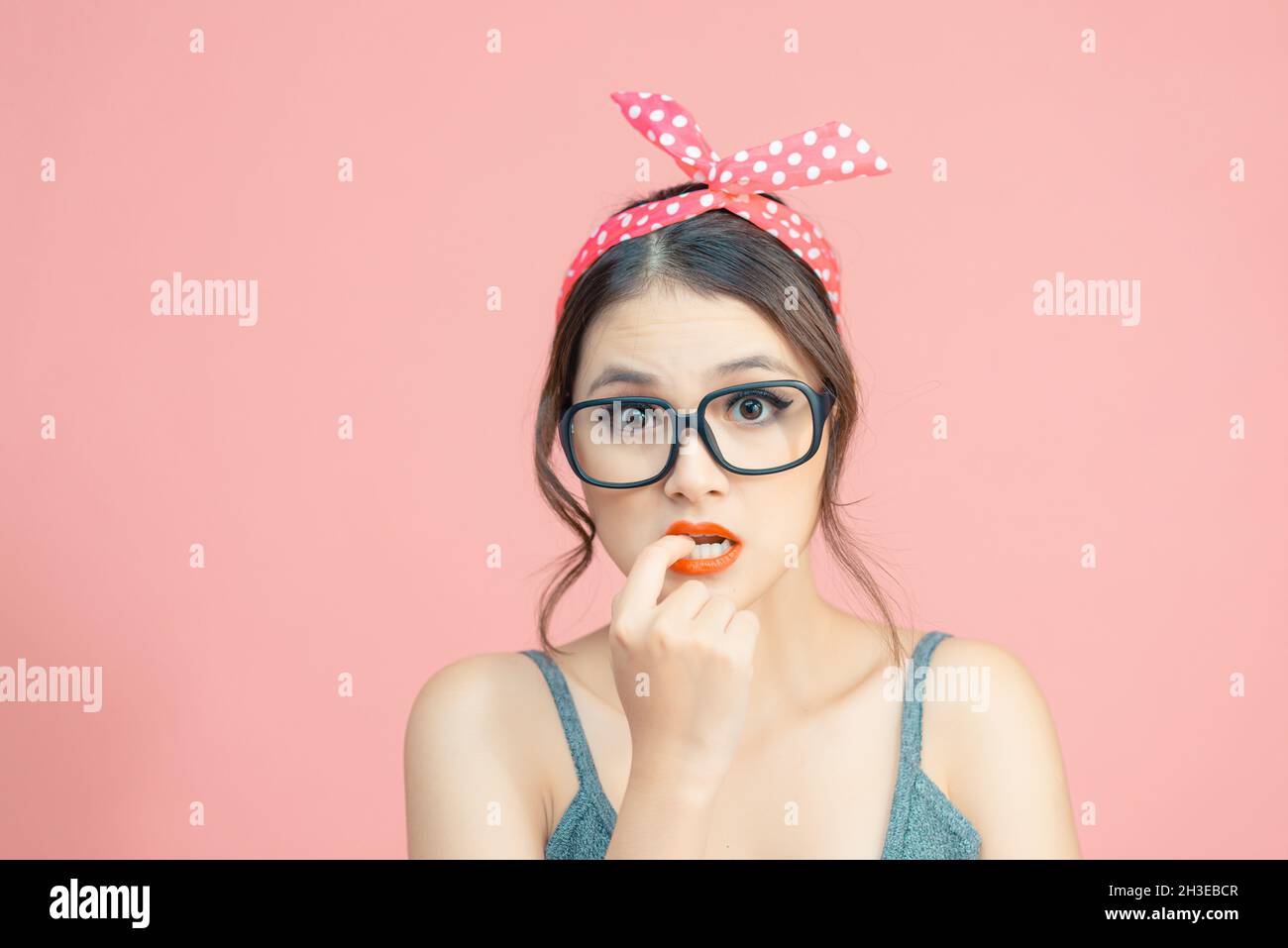 Shy beautiful woman looking away against pink background Stock Photo ...