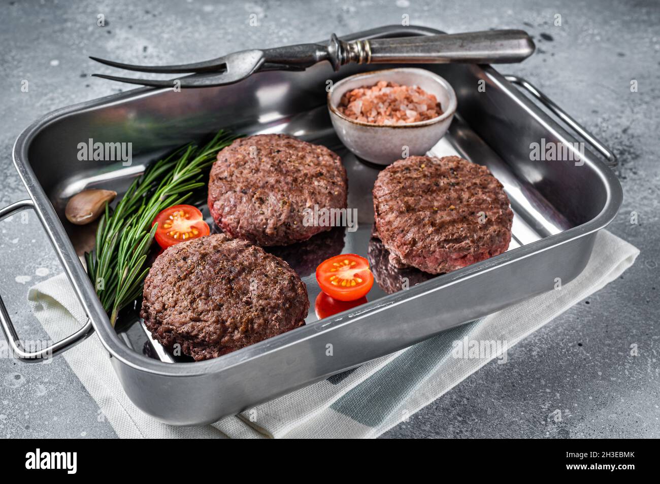 Burger beef meat steak patties with herbs. Gray background. Top view ...