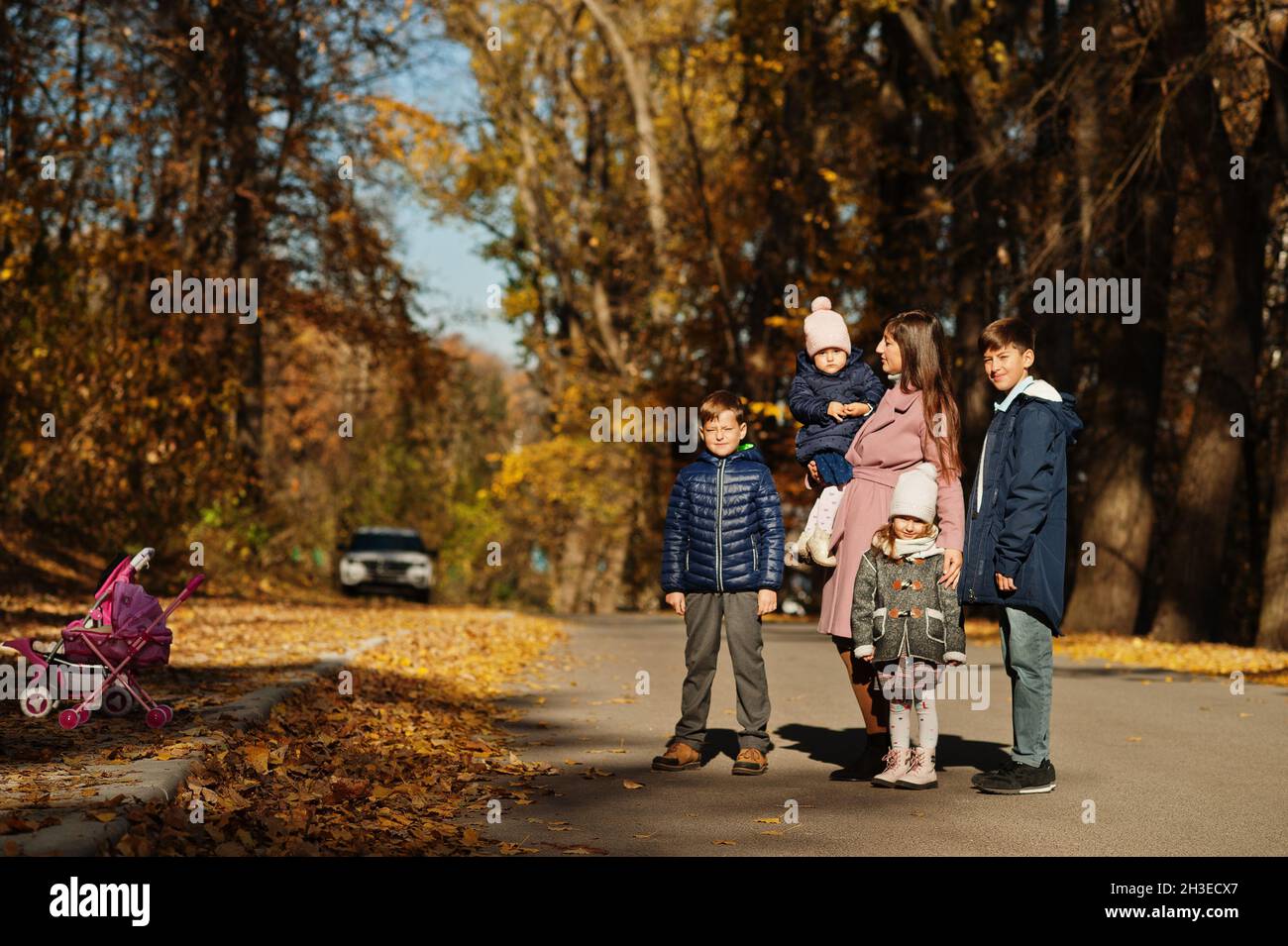 Mother with four kids in autumn park. Family walk in fall forest Stock ...