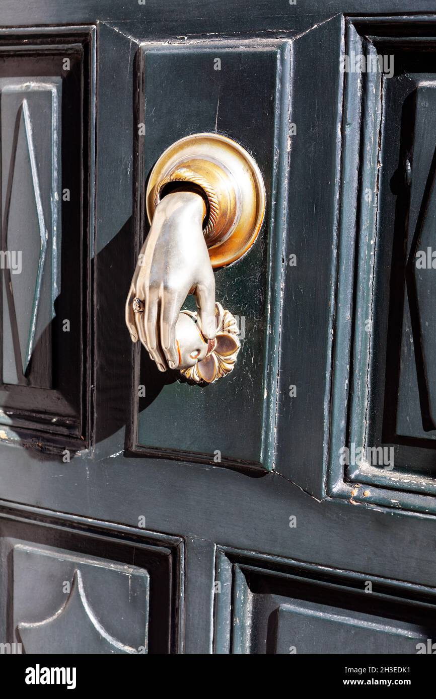 Hand shaped handle of wooden door . Black door in medieval style ...