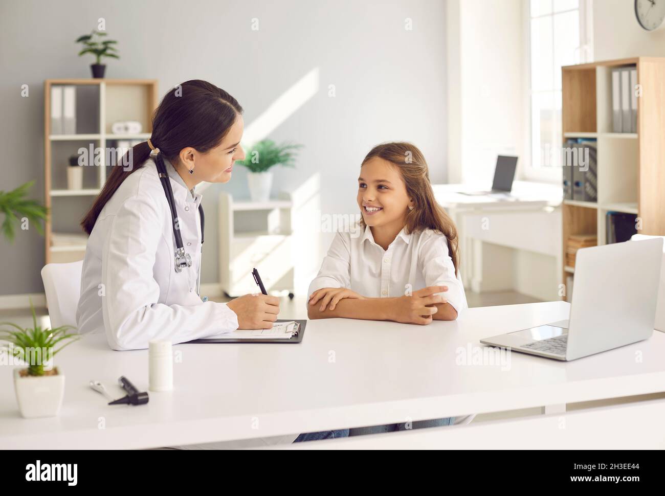 Caring female doctor consult small girl patient Stock Photo - Alamy