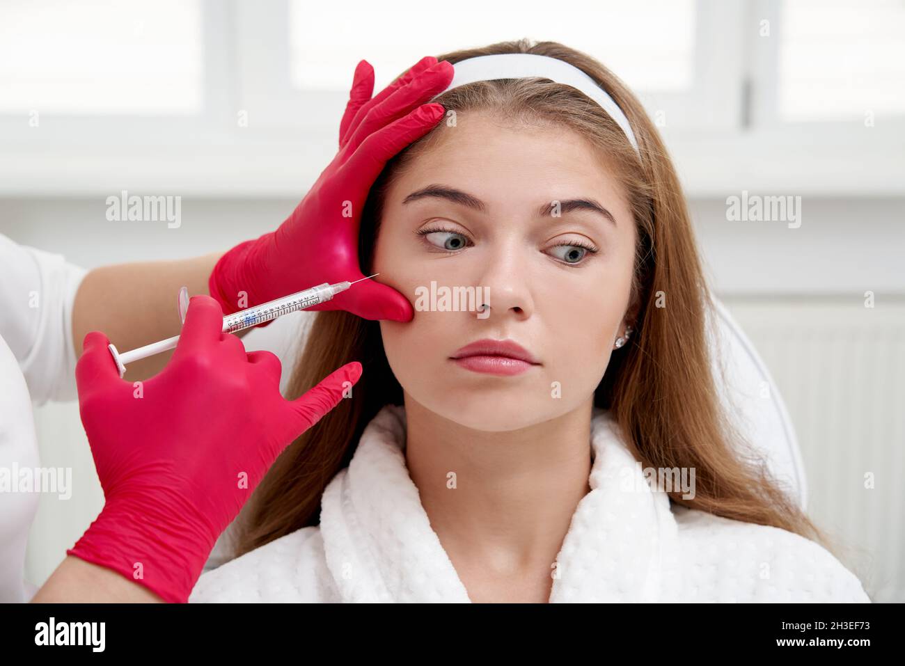 Beauty injections into young female face. Smoothing of mimic wrinkles ...
