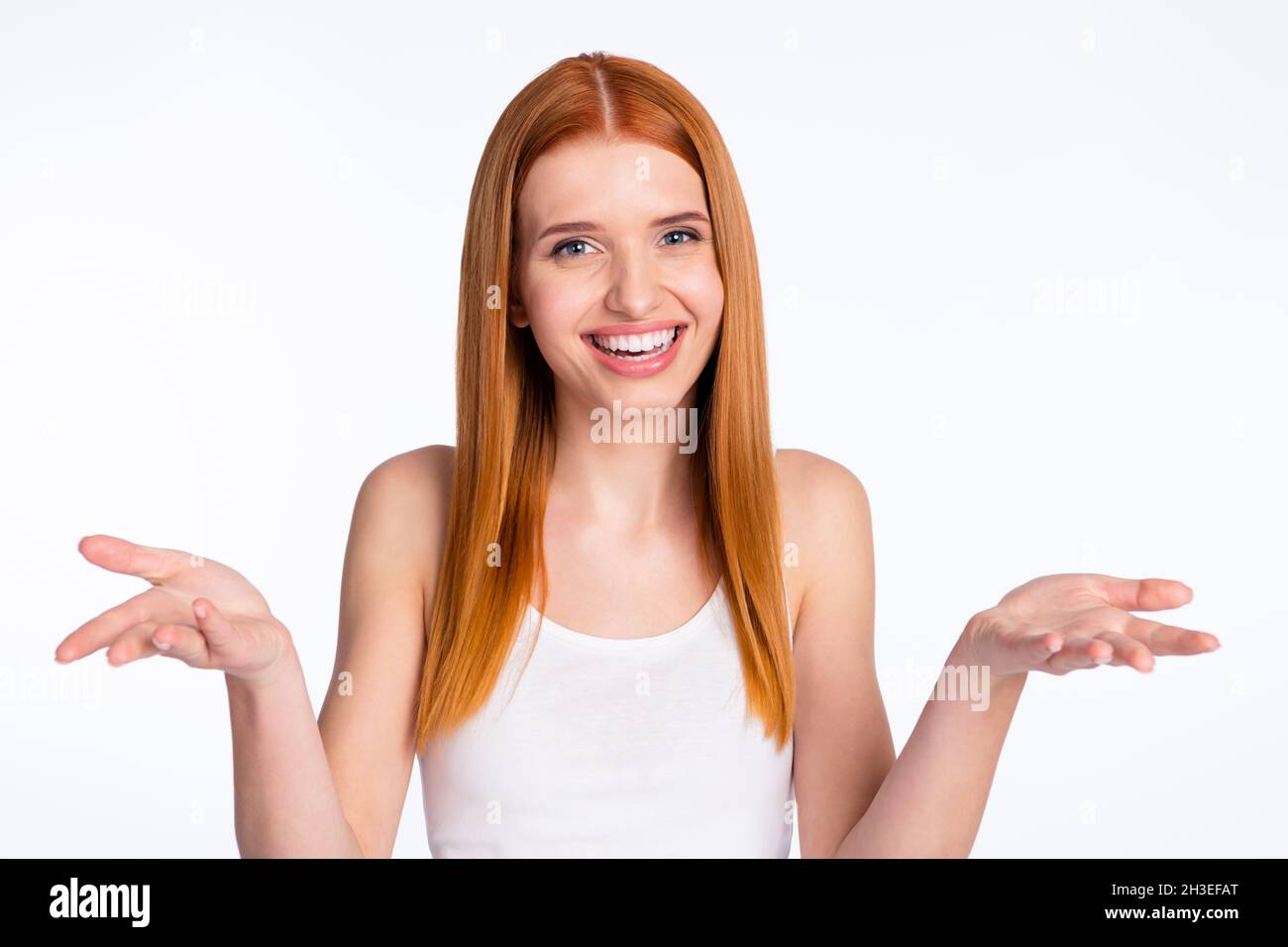 Photo of positive red haired girl raising hands saying news isolated ...