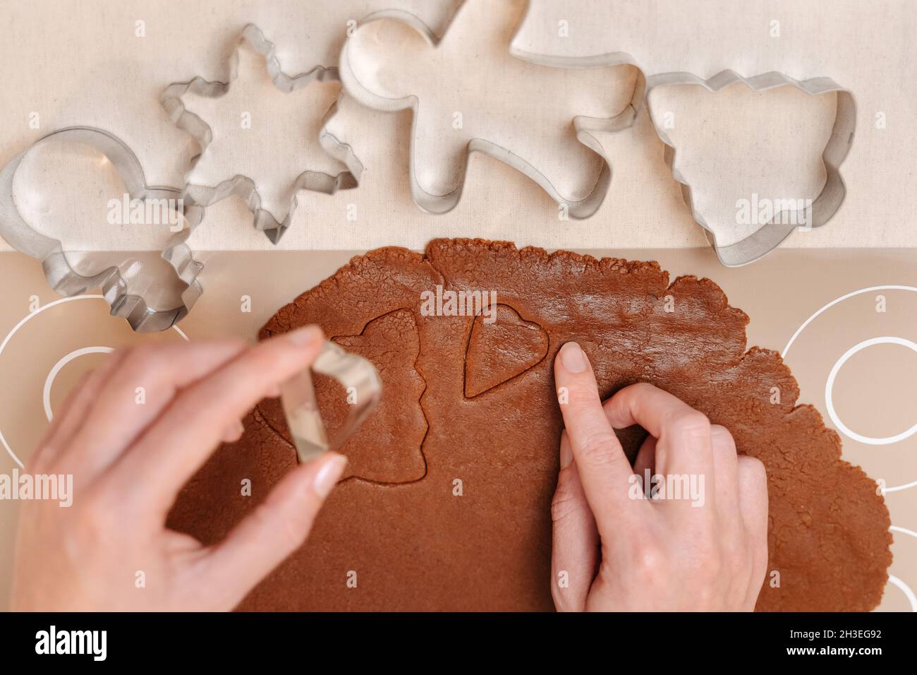 Gingerbread dough with metal cutters of different shapes Stock Photo ...